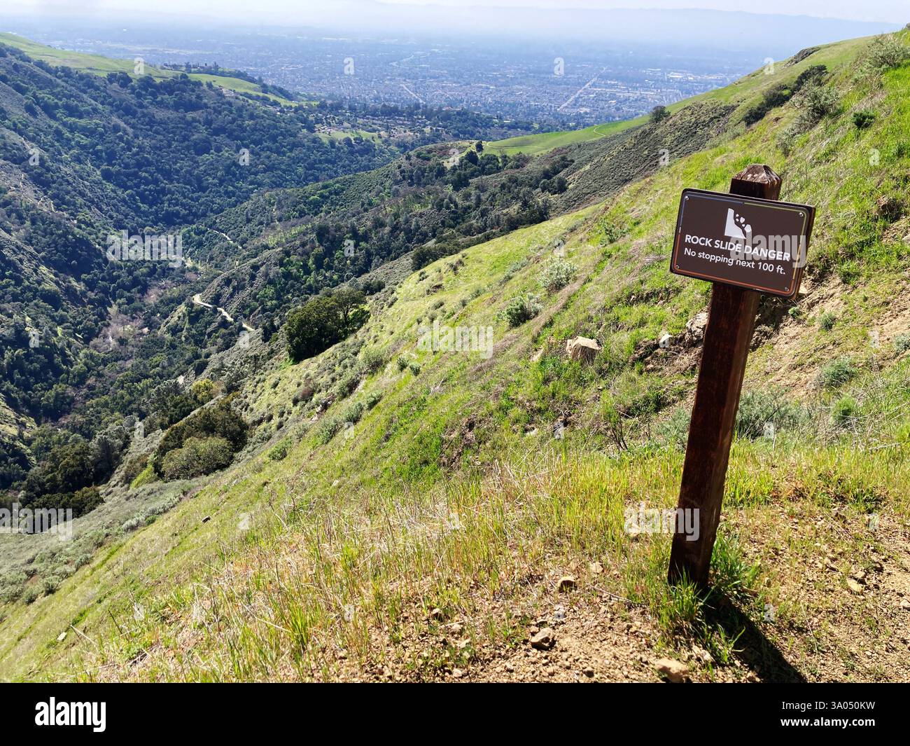 Rock Slide Danger. No stopping next 100 ft warning sign overlooking a ...