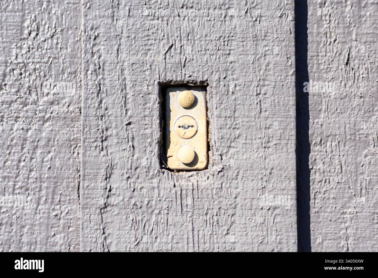 Rectangular metal recessed keyhole plate with two screws is mounted on ...