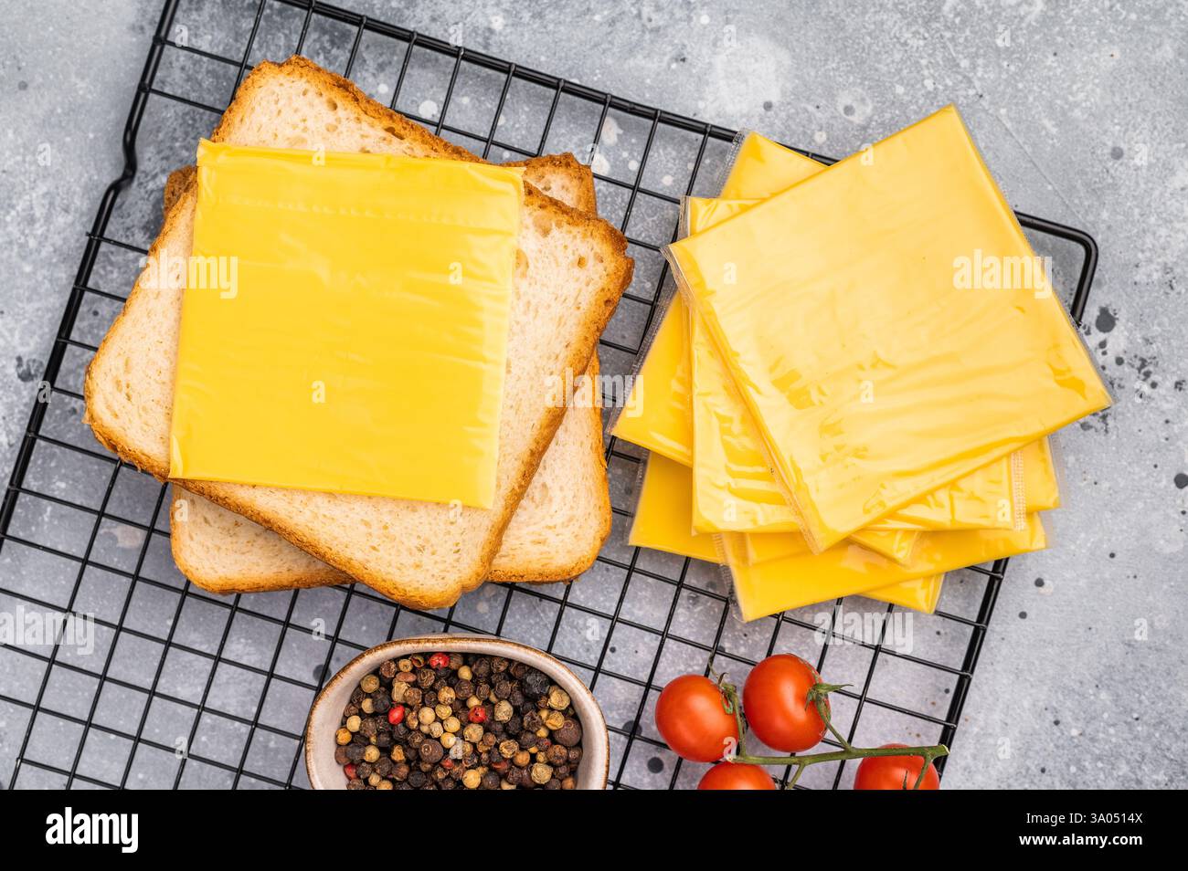 Square Slices of processed Cheddar cheese in individual plastic ...