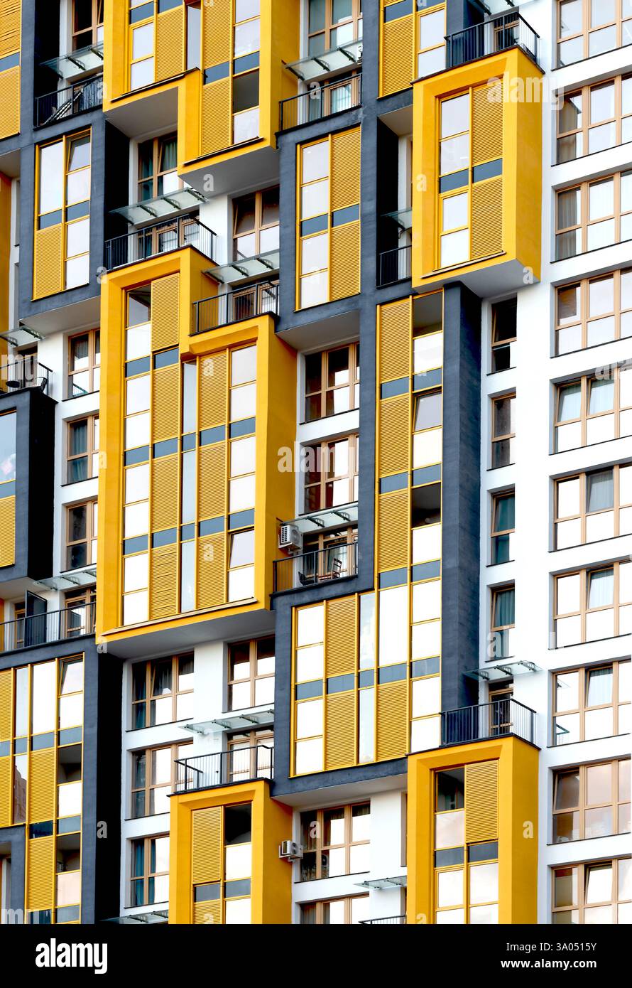 Bright yellow condominium under construction in urban downtown. Multi ...