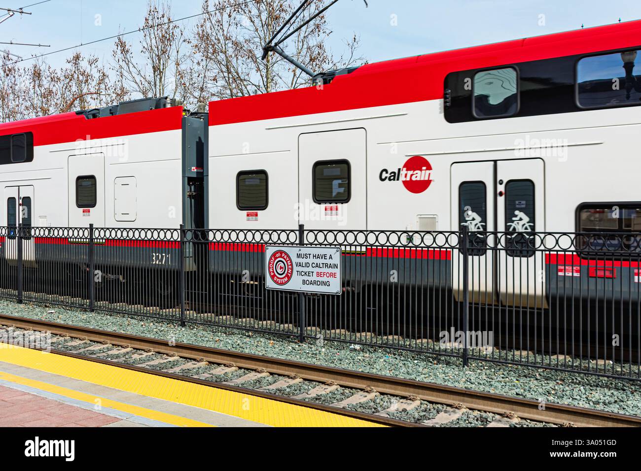 Caltrain double-decker train behind a safety fence with Proof-of ...