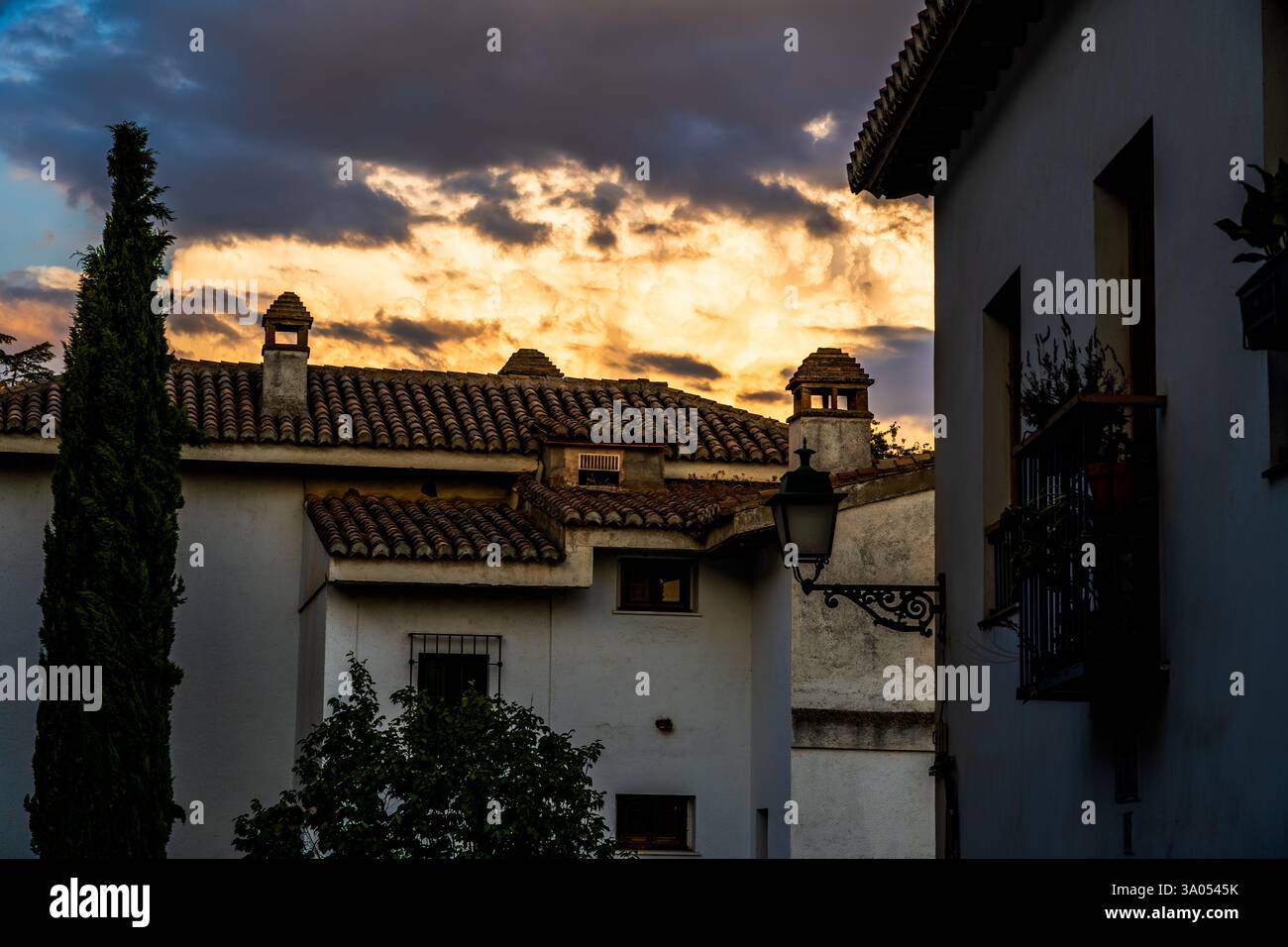 Dramatic Dusk Over Granada Rooftops, Clay Chimneys, and White Facades ...