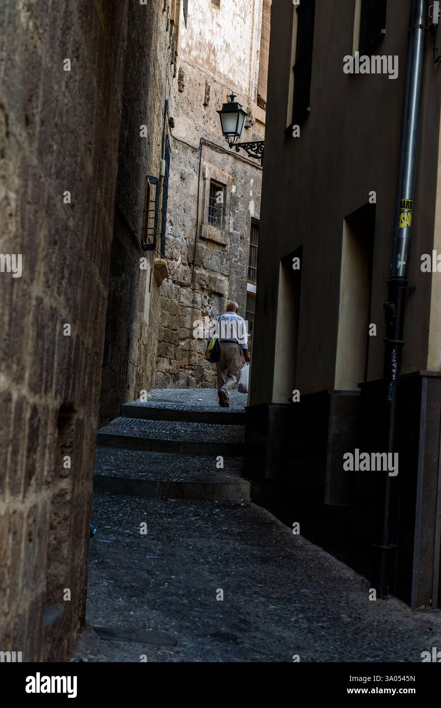 Man Walking Stone Steps in Granada’s Medieval Alley, Revealing ...