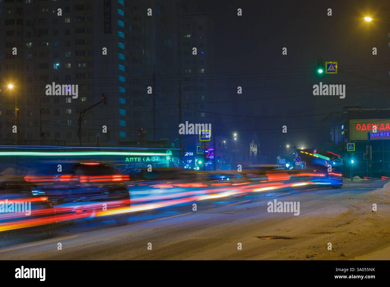 Colorful streaks of light from cars driving on a city street at night ...