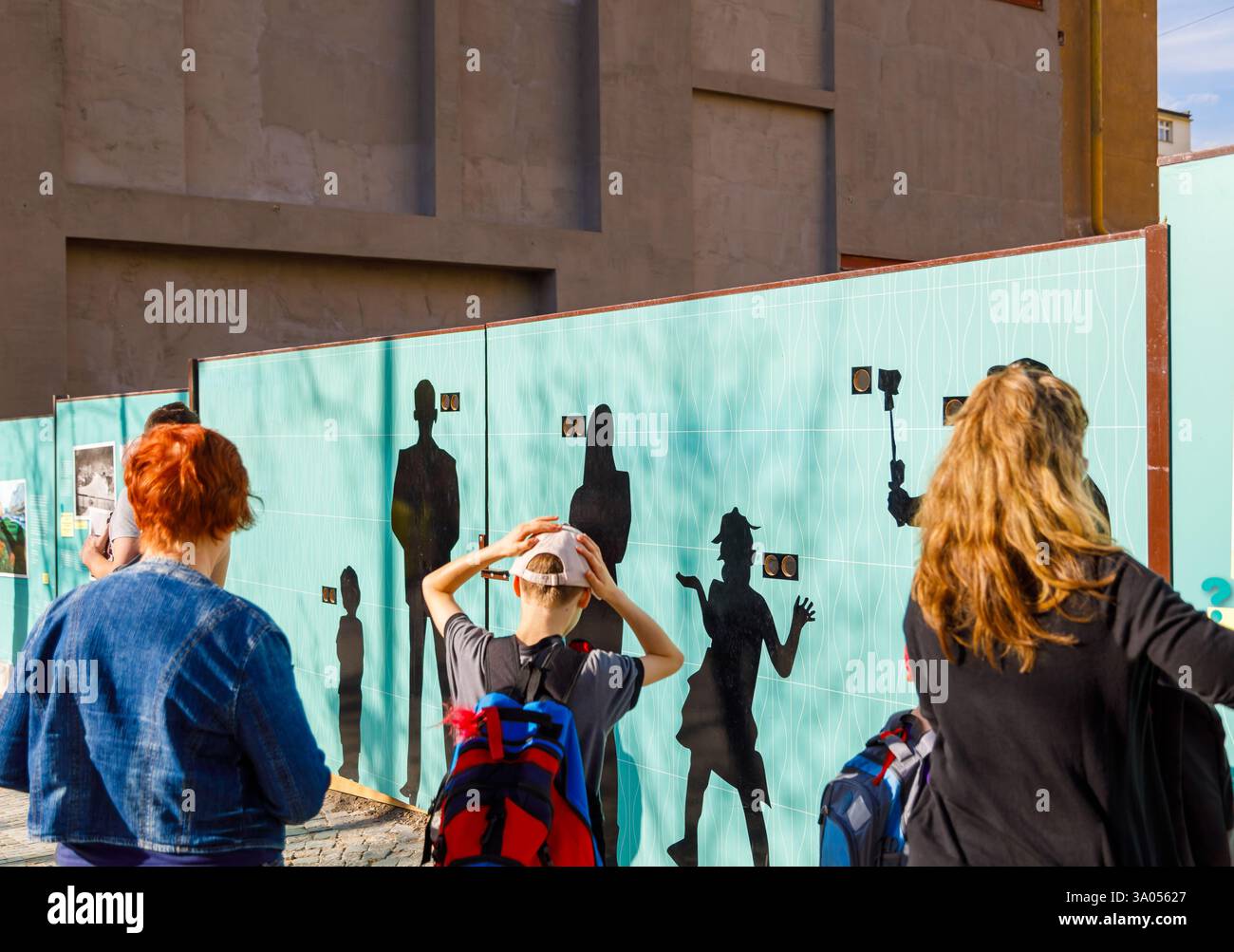Family having fun posing with shadow puppets simulating taking pictures ...