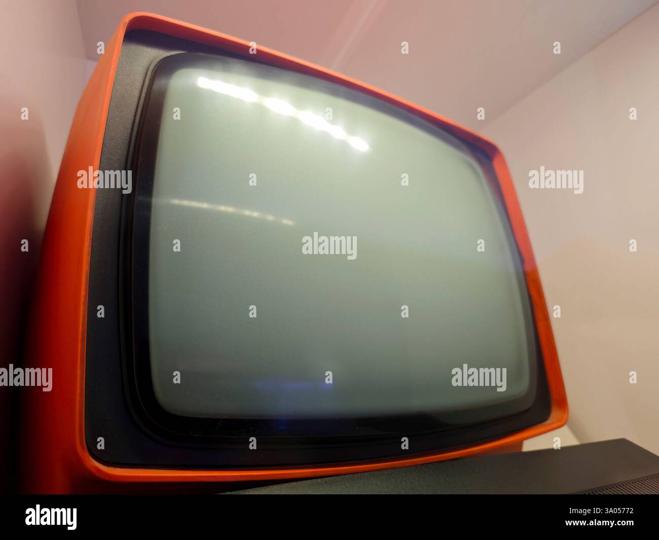 Large vintage orange retro television set with blank empty screen close ...
