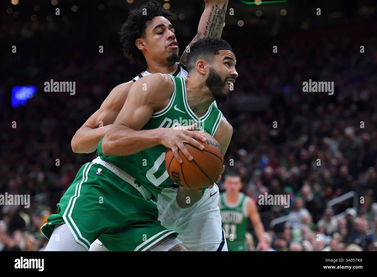 Boston Celtics forward Jayson Tatum (0) drives past Denver Nuggets ...