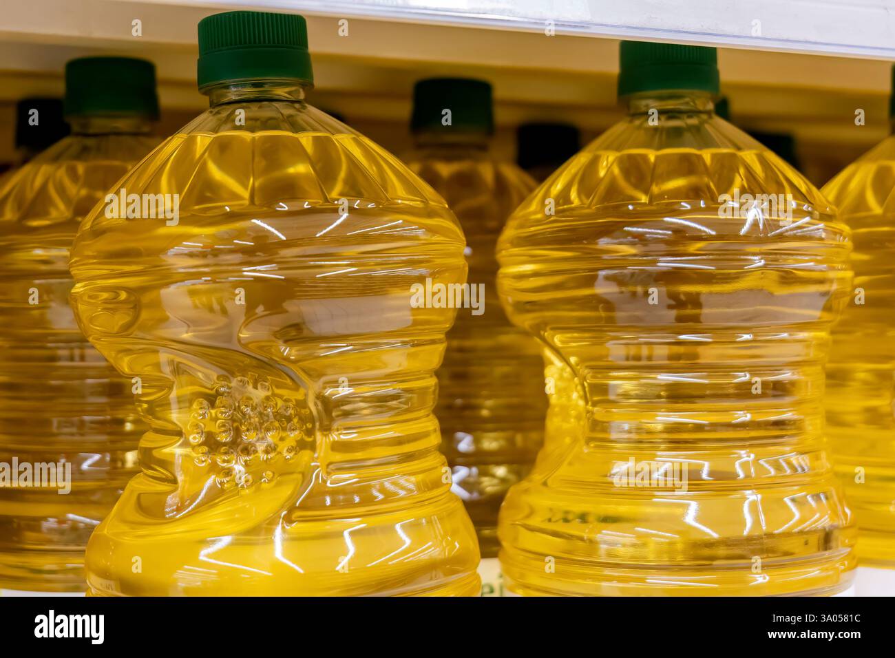 Large plastic unbranded 5 liter 1 gal bottles full of cooking oil on ...