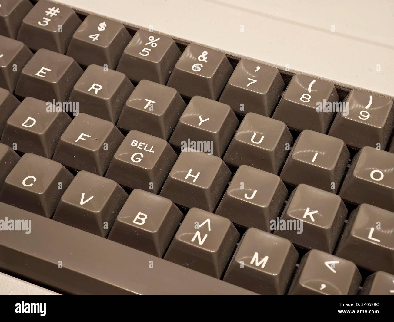 Old grey computer keyboard with bell key closeup, vintage style keys ...