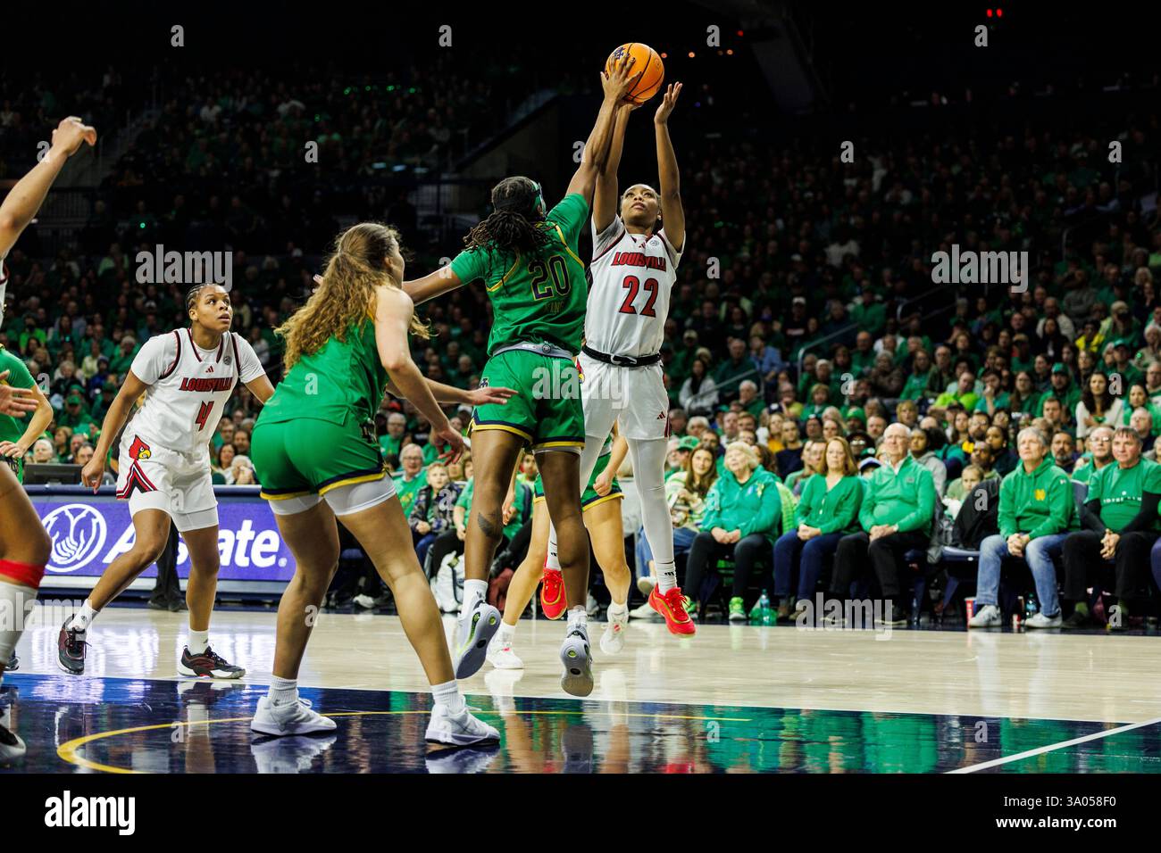Louisville guard Tajianna Roberts (22) shoots over Notre Dame forward ...