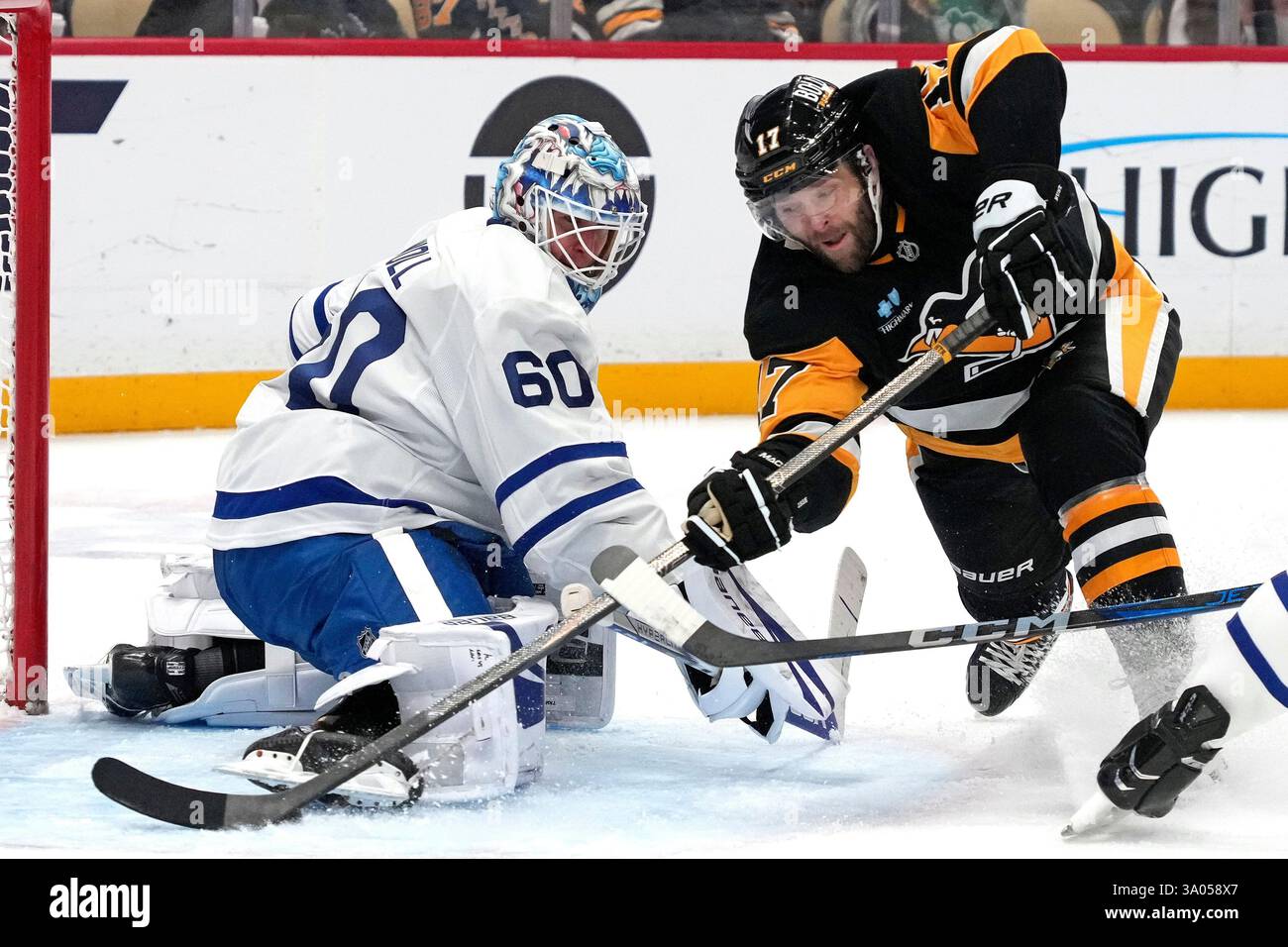 Pittsburgh Penguins' Bryan Rust (17) backhands a shot past Toronto ...