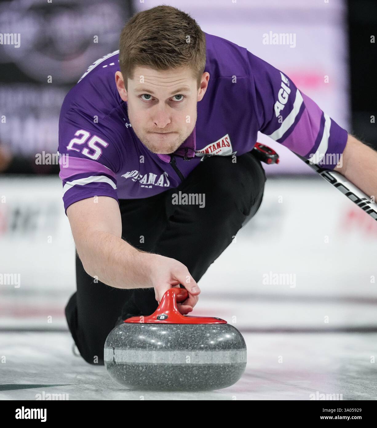 Yukon skip Thomas Scoffin delivers a rock while playing Quebec during ...