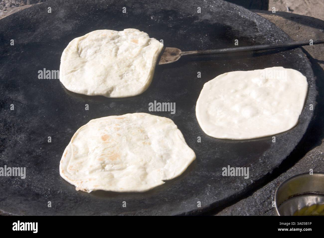 Paratha baking on round iron surface, West Bengal, India, Asia Stock ...
