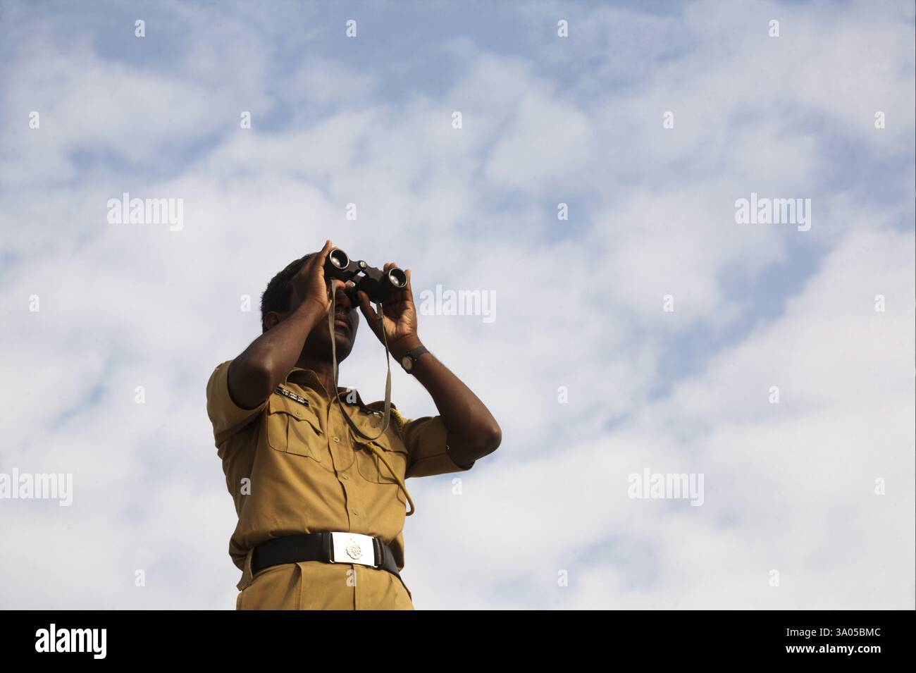 A policeman keeping a watch over the Eid al Fitr or Ramzan id namaaz at ...