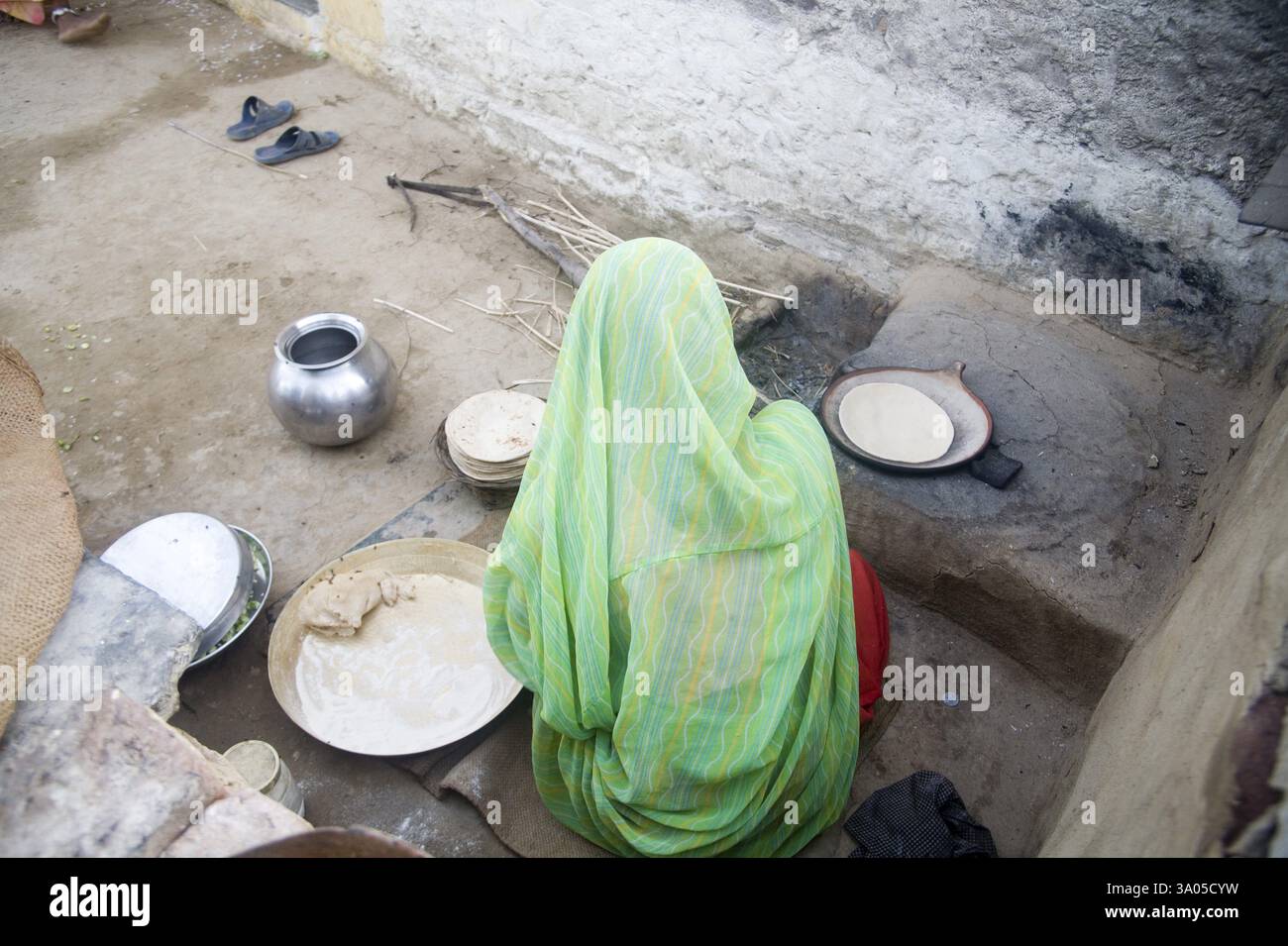 Rural women making roties an Indian bread, Village Delwada, Udaipur ...