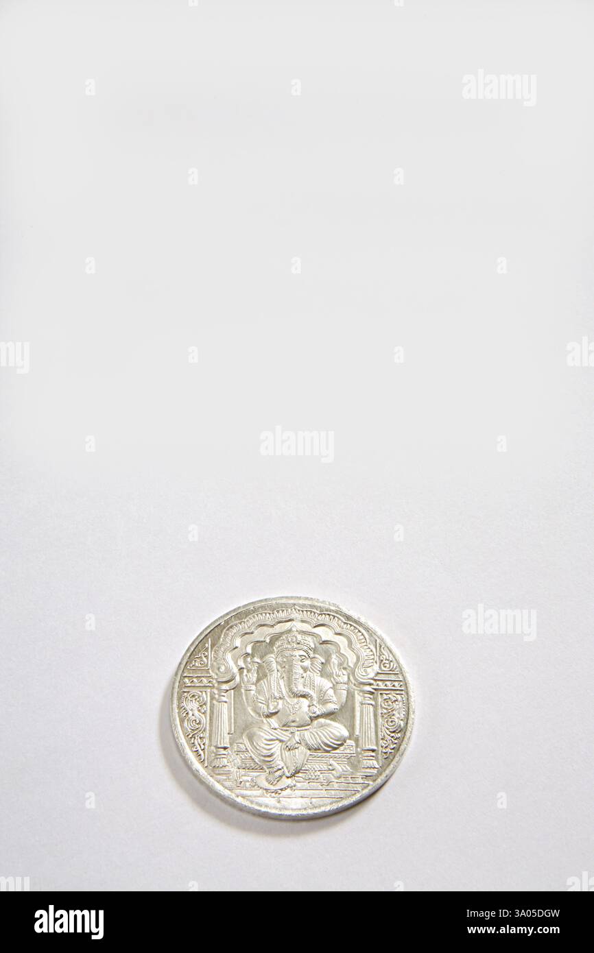 Concept, silver coin of god ganesh on white background Stock Photo - Alamy