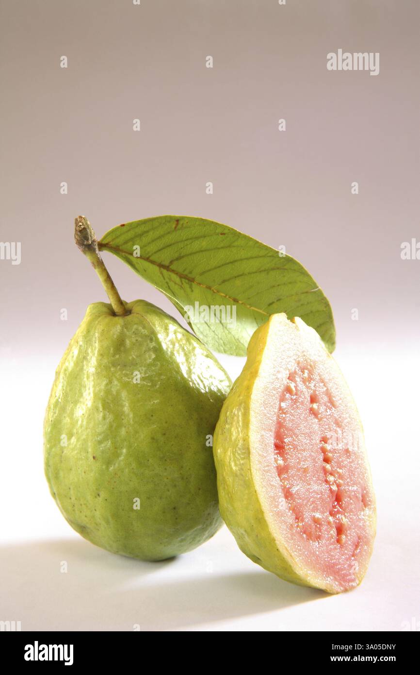 Fruits, amrood one full and half guava psidium guyava with green leaf ...