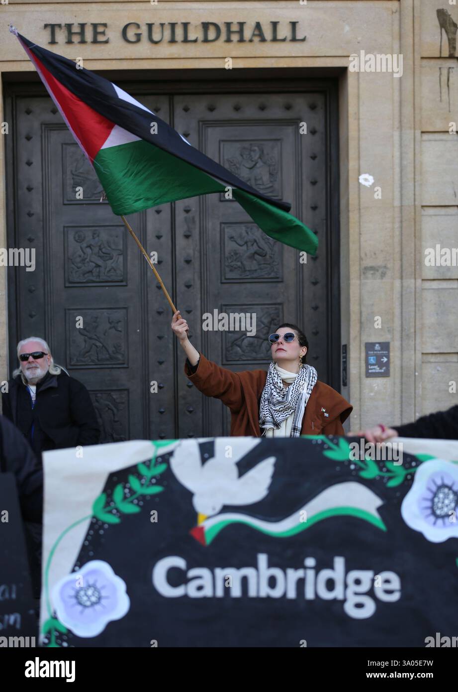 A protester waves a Palestinian flag in front of the Guildhall building ...