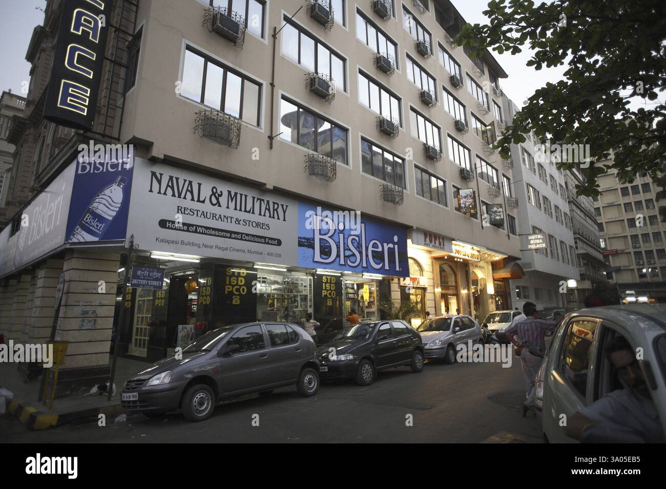 Cars parked outside shops in Colaba, Bombay now Mumbai, Maharashtra ...