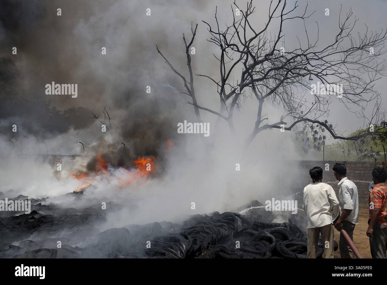 Firemen trying to douse off fire while scrap warehouse, Jodhpur, Rajasthan, India, Asia Stock ...