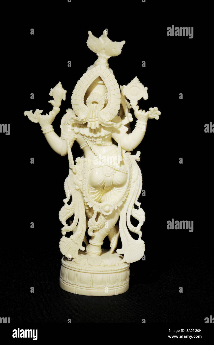 Statue made by elephants tusk on black background Stock Photo - Alamy