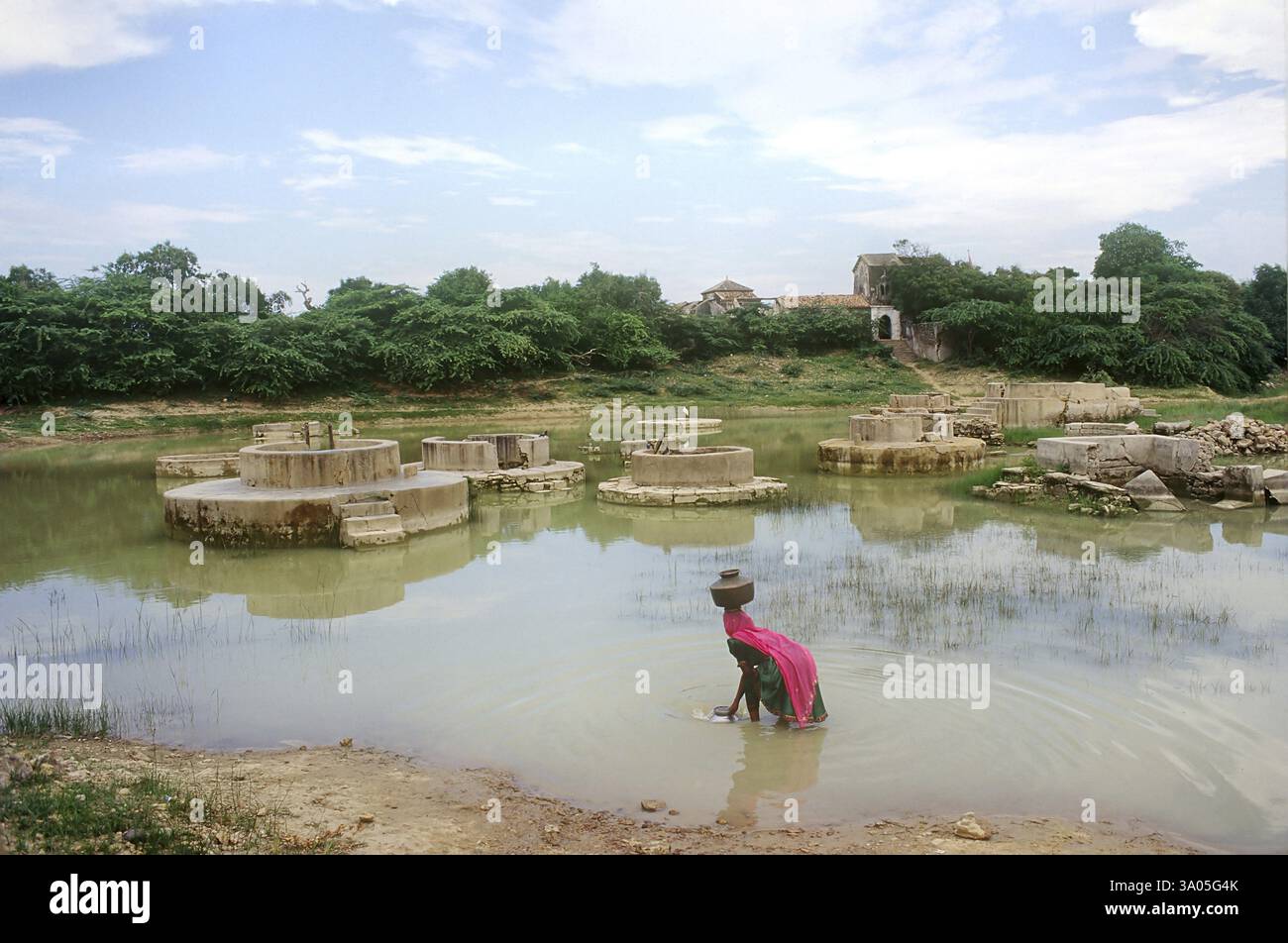 Woman collecting rain water from a pond When the pond dries up wells ...
