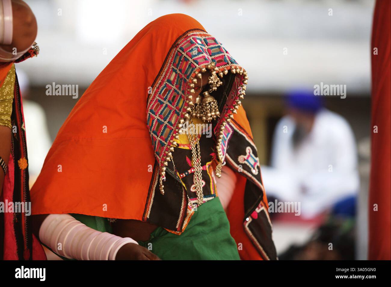 Nomad woman dressed in their traditional colourful attire sitting ...