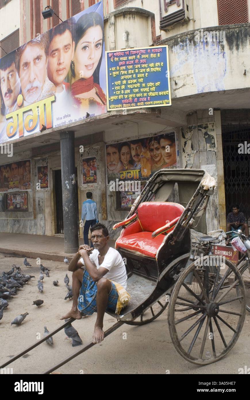 Hand Rickshaw Puller sitting in his Rickshaw on street waiting for ...