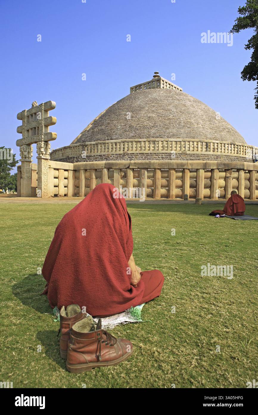 Buddhist monk reading scriptures in front of Stupa 1 constructed by ...