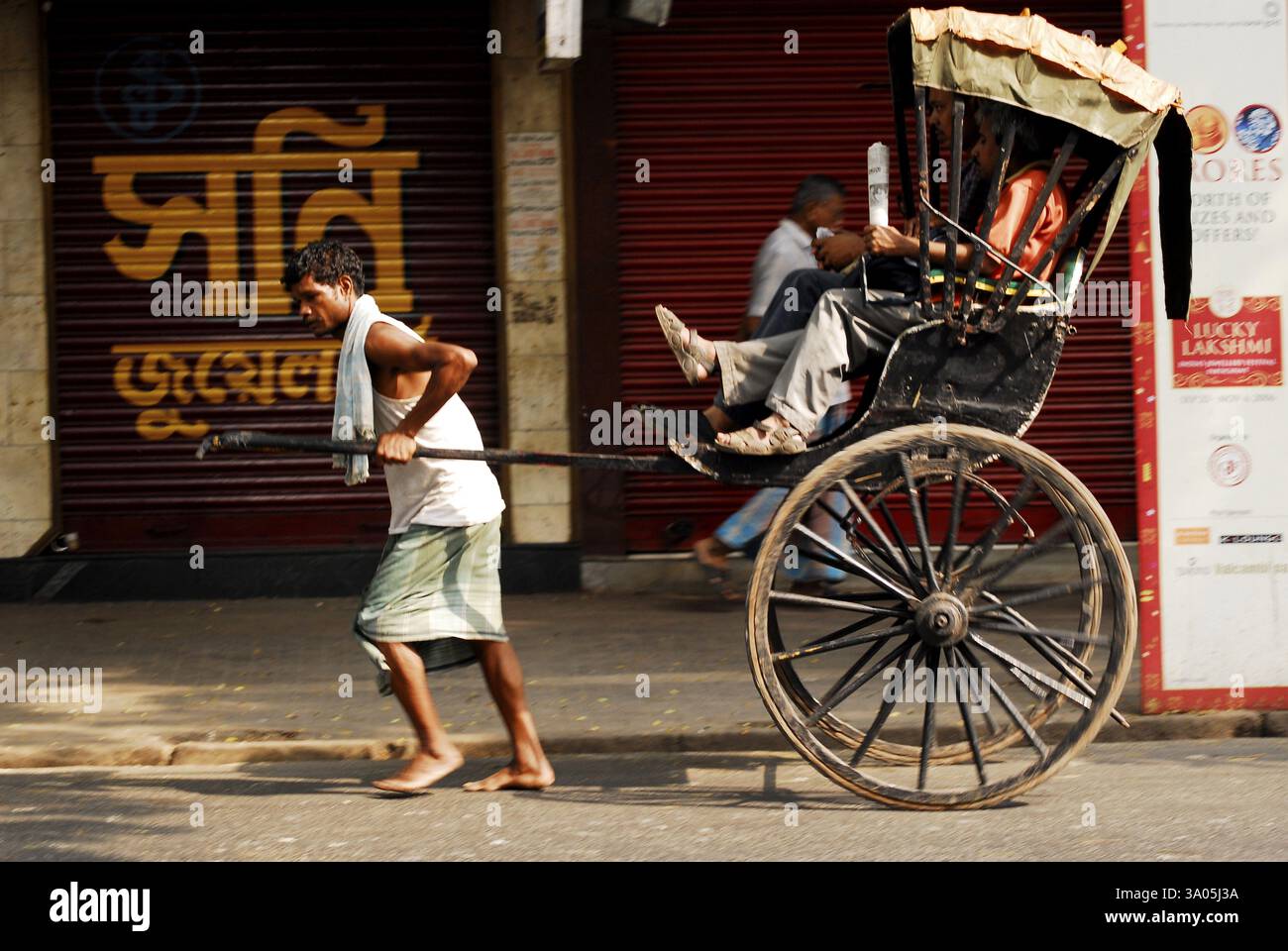Hand Rickshaw Puller pulling with Passenger, Kolkata, West Bengal ...