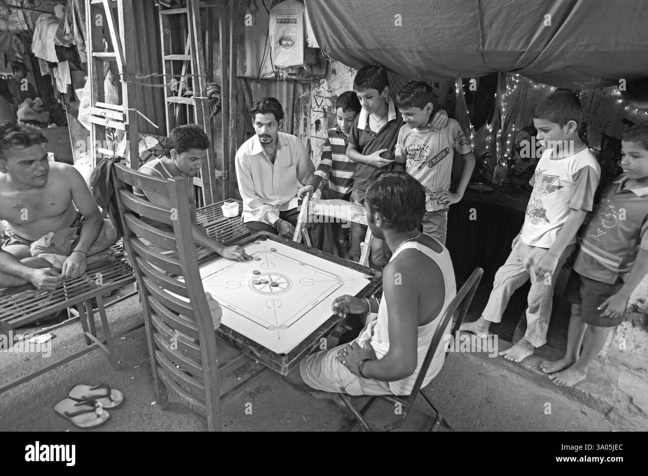 Dwellers playing carom in bhagatsingh nagar slum, Wadala, Bombay Mumbai ...