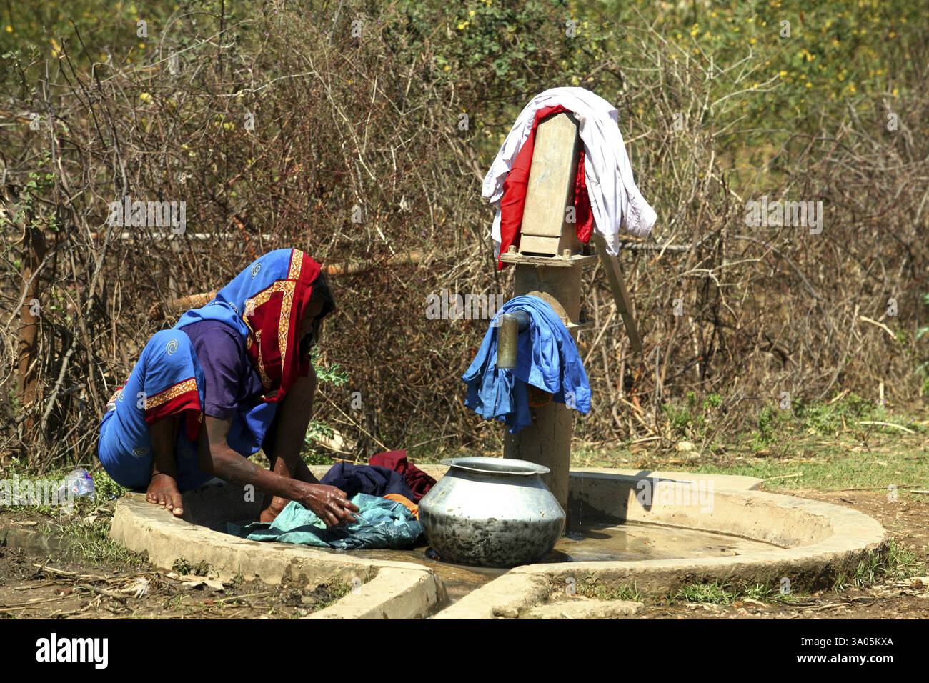 Lady washing clothes at village water pump in Jharkhand, India, Asia ...