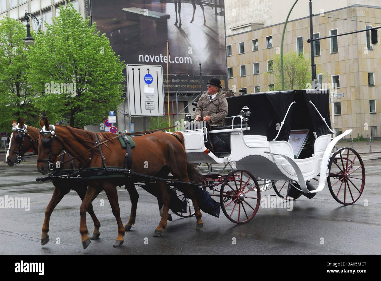 Old fashioned horse driven carriages still running on streets, Germany ...