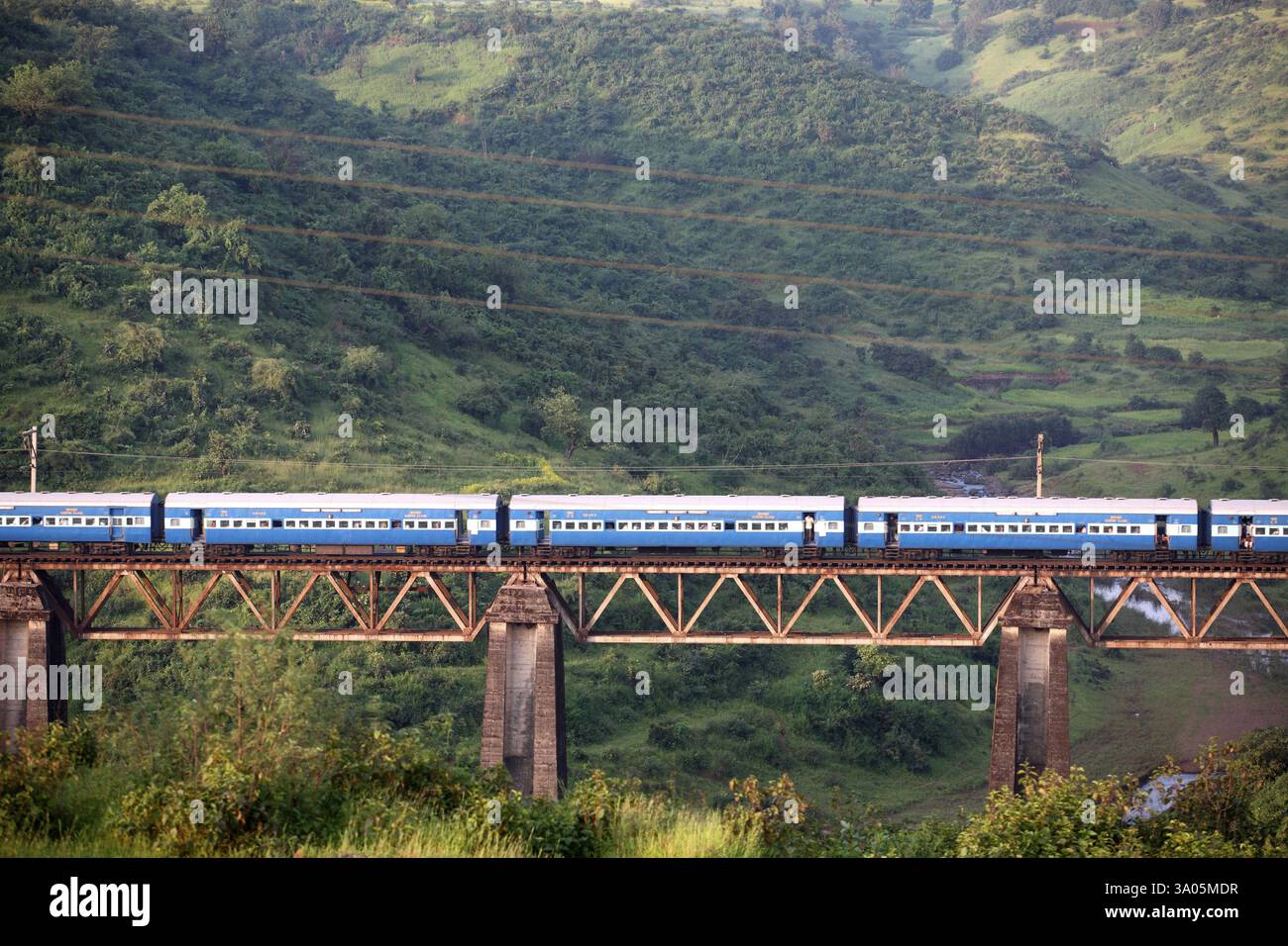 Indian Railways train passing by heightened up bridge at Igatpuri near ...
