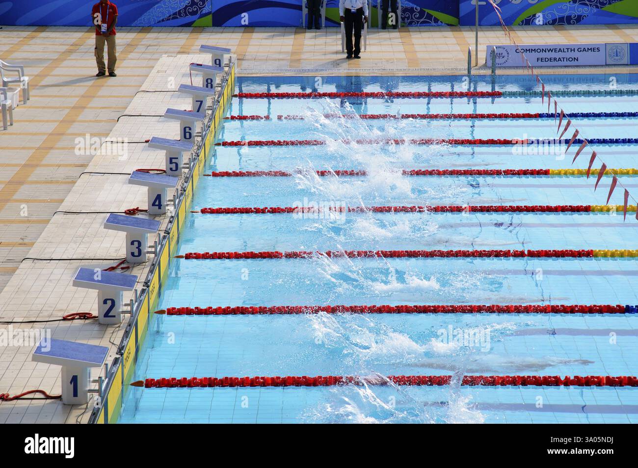 Swimmers diving in swimming pool splashing water in shree shiv ...