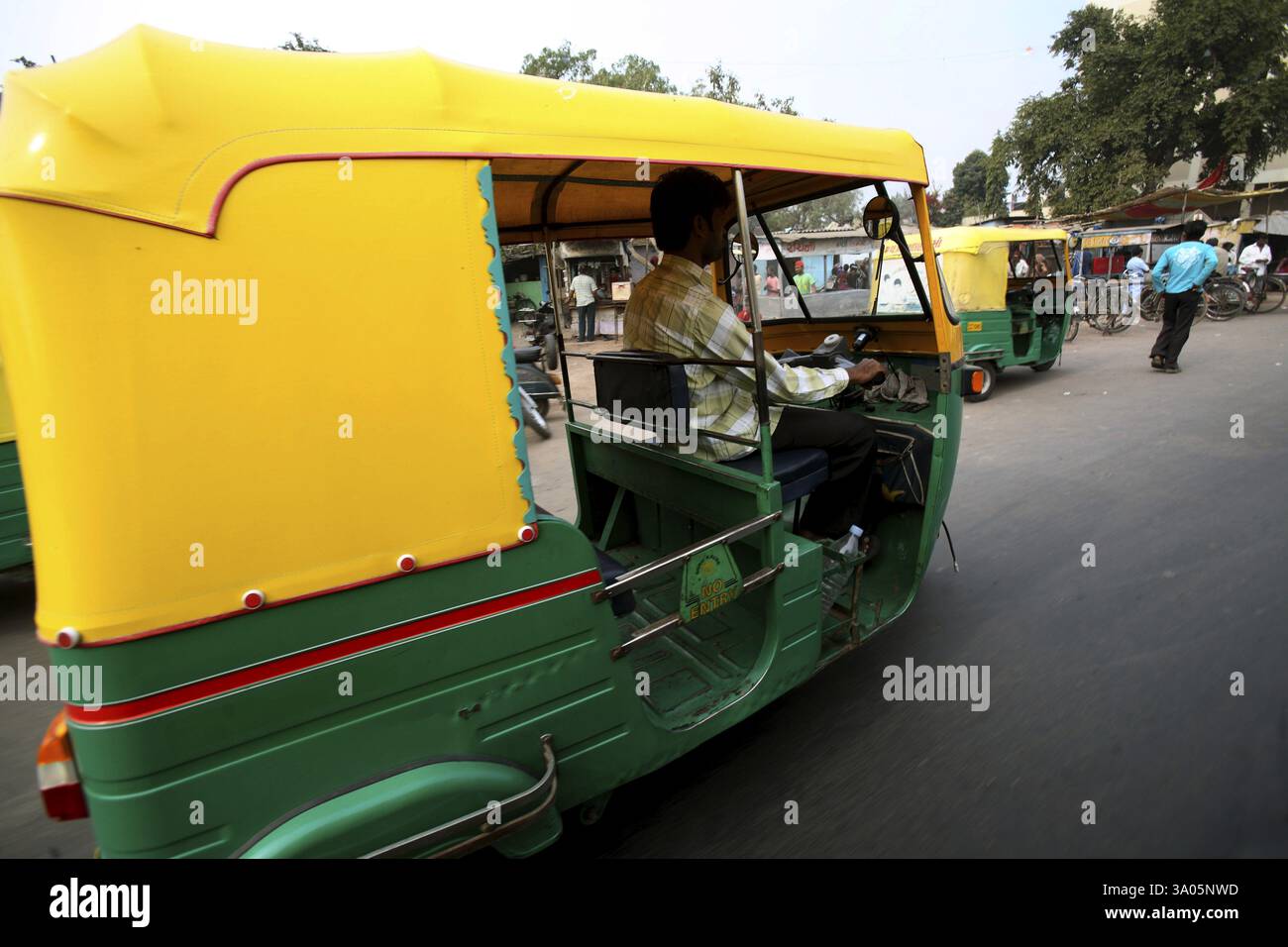 Auto-rickshaw driver driving rickshaw on streets of India Stock Photo ...