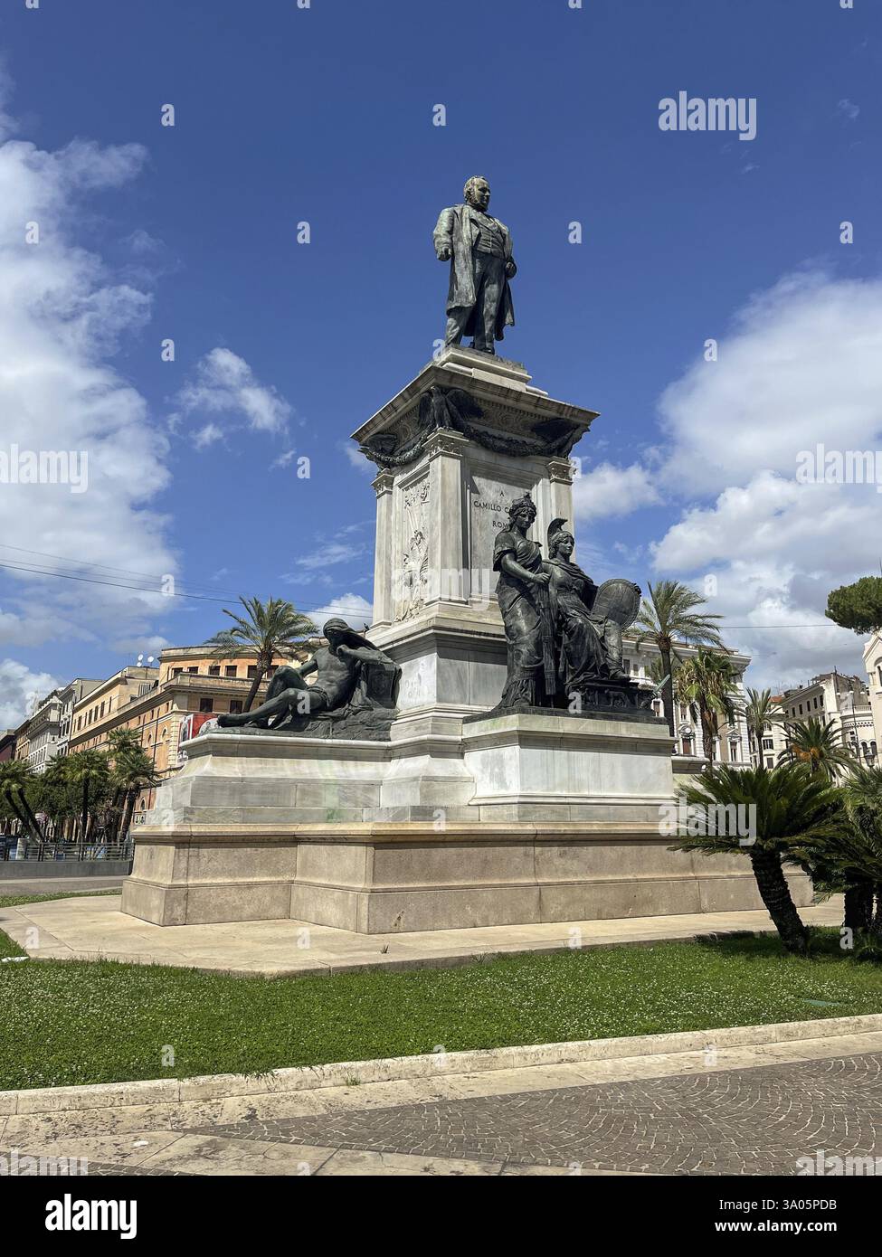 Imposing monument and statue surrounded by palm trees under a sunny sky ...
