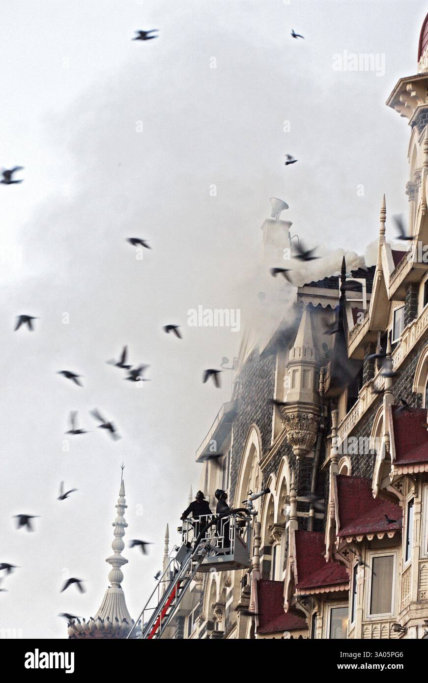 Fire fighters try to douse fire inside of Taj Mahal hotel after ...