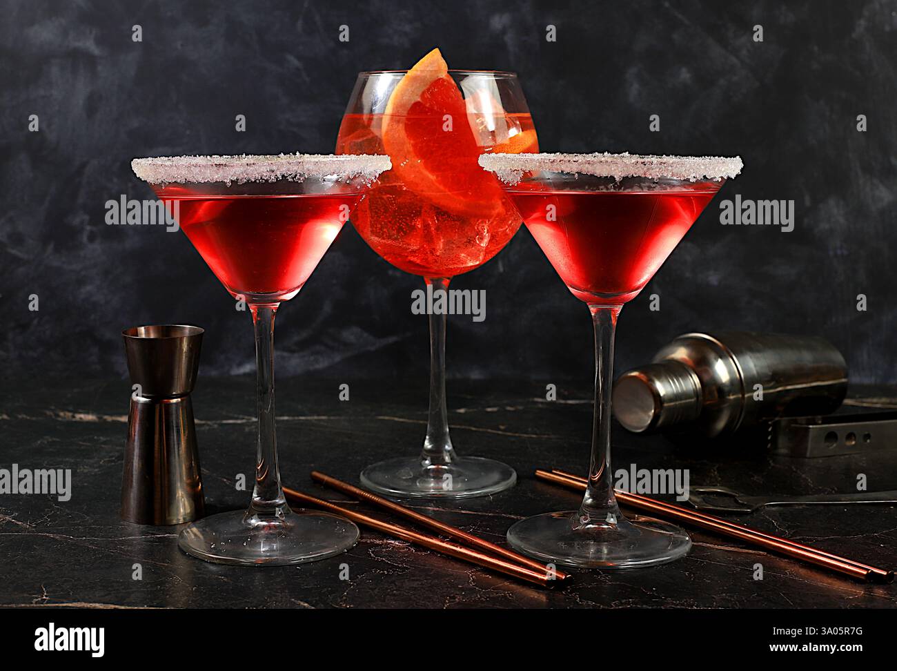 champagne and red martini in glasses on a dark background, bar concept ...