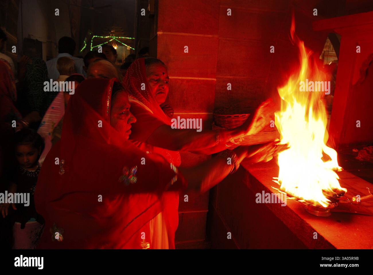 After arti women are taking heat of sacred fire flame in temple ...
