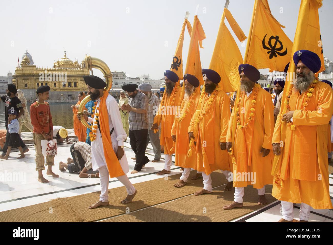Orange color dressed Sikh men taking out the procession Guru Ramdas ...