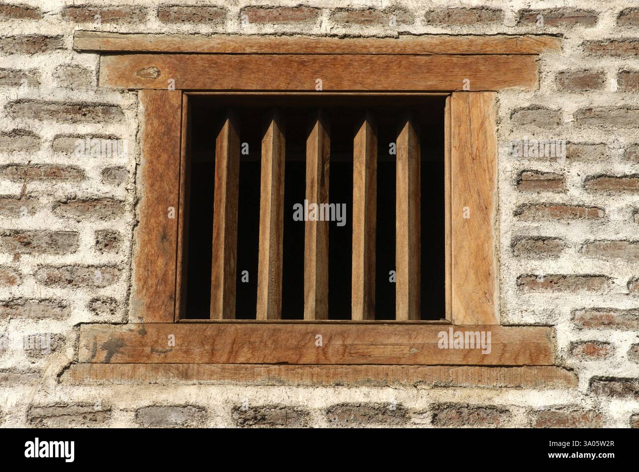 Wooden window frame, square wood bars fixed brickwork at entrance of ...
