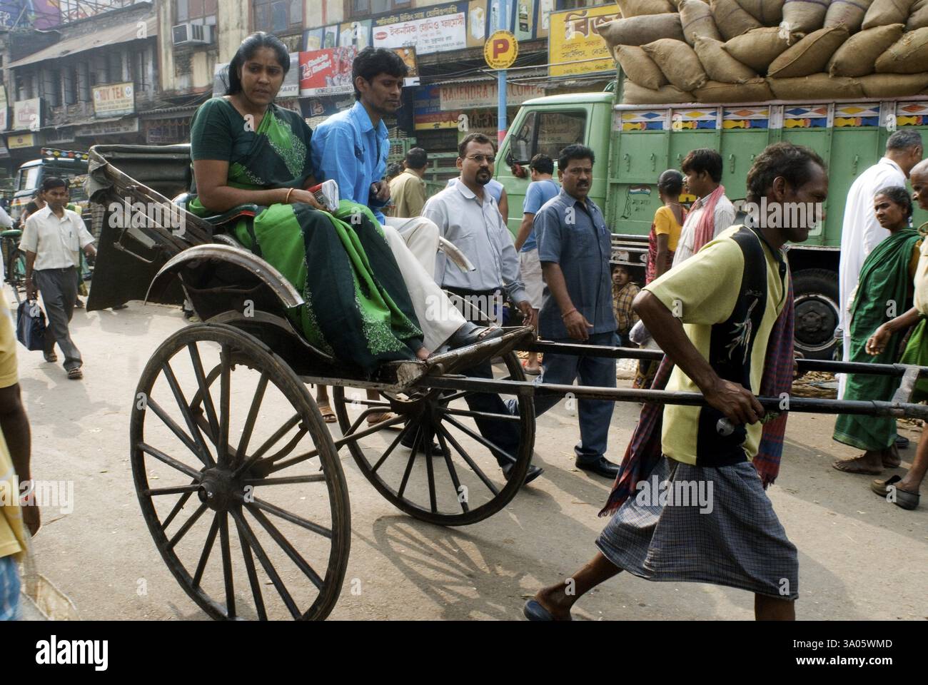 Hand Rickshaw Puller pulling with Passenger, Kolkata, West Bengal ...