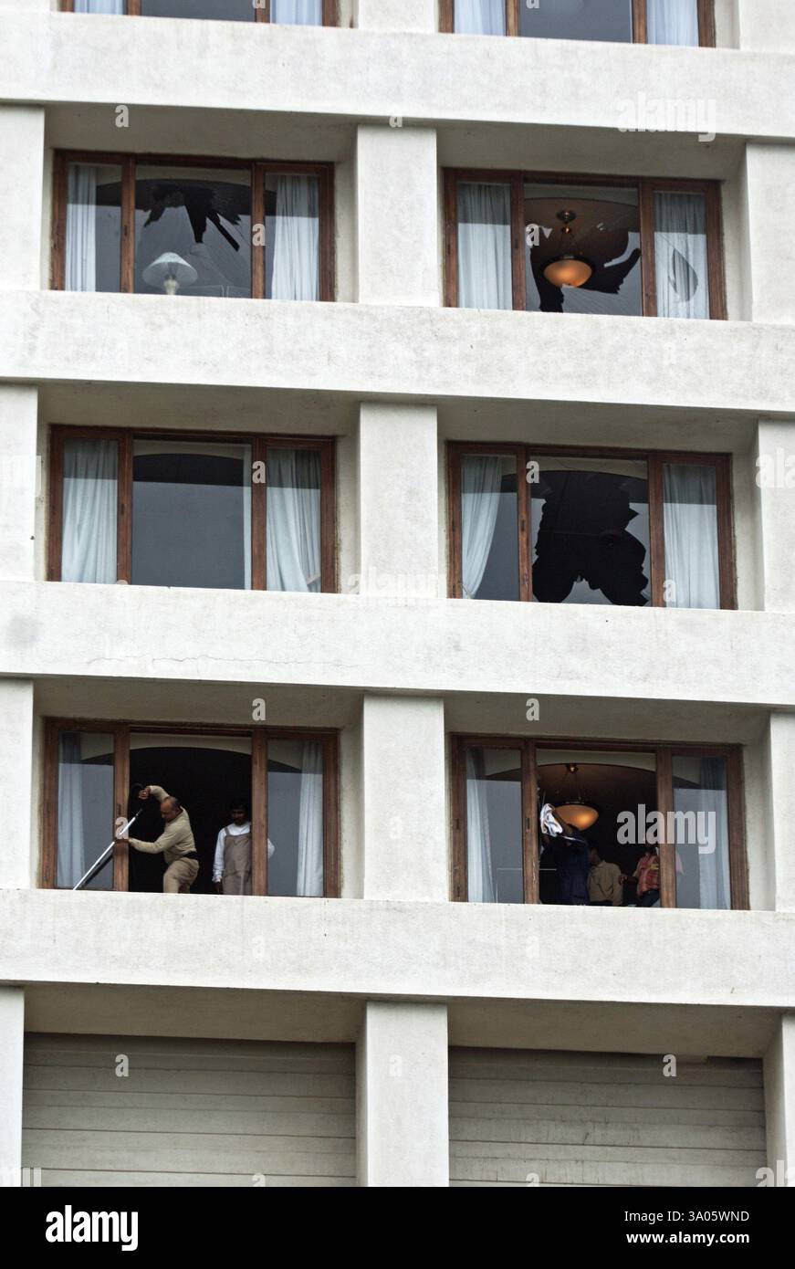 Workers cleaning windpanes of hotel Trident after terrorist attack by ...