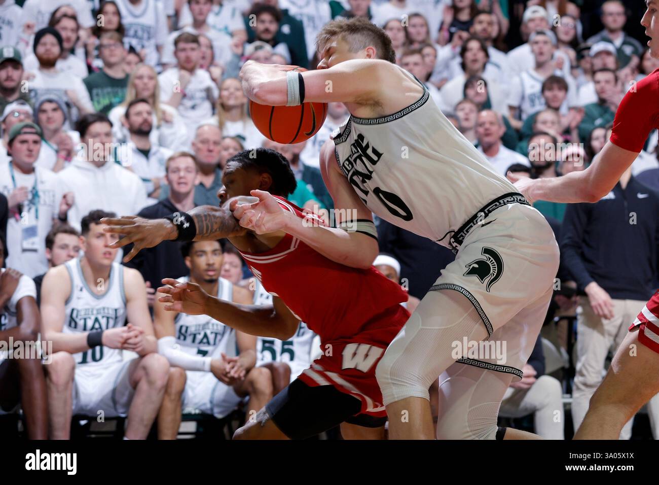 Michigan State forward Jaxon Kohler (0) and Wisconsin guard Kamari ...