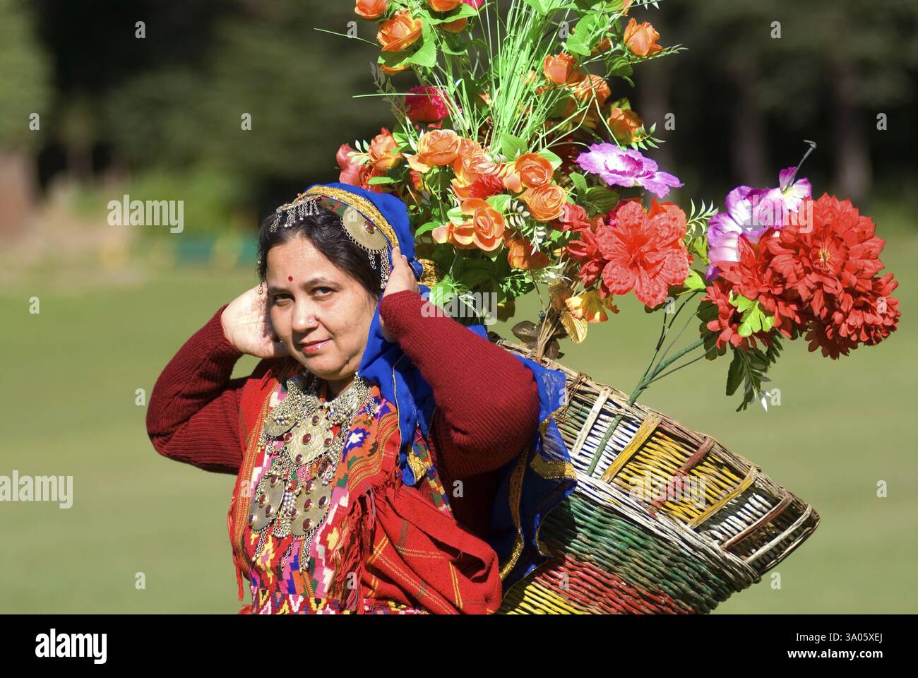 Women in traditional dress holding rabbit at khajjiar, Himachal Pradesh ...