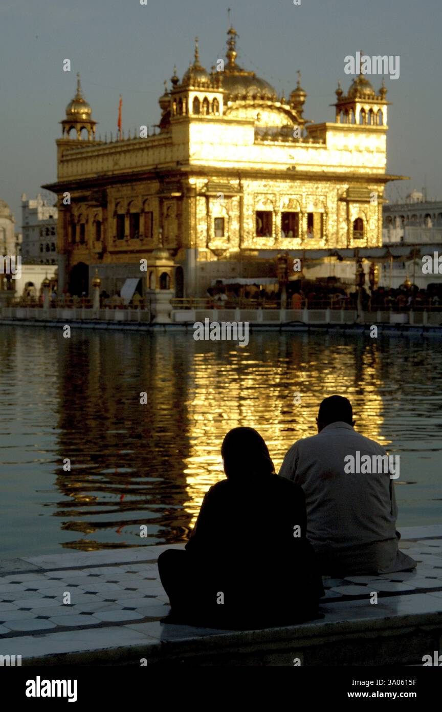 Sikh sitting on the marble steps of Amrit sarovar the lake of nectar ...