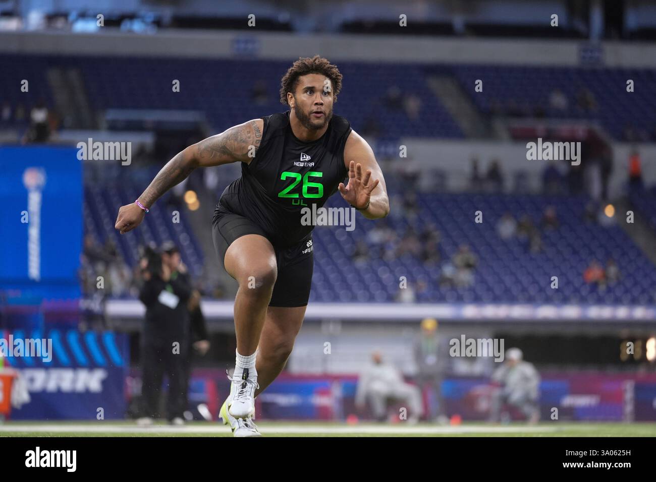 Purdue offensive lineman Marcus Mbow runs a drill at the NFL football ...