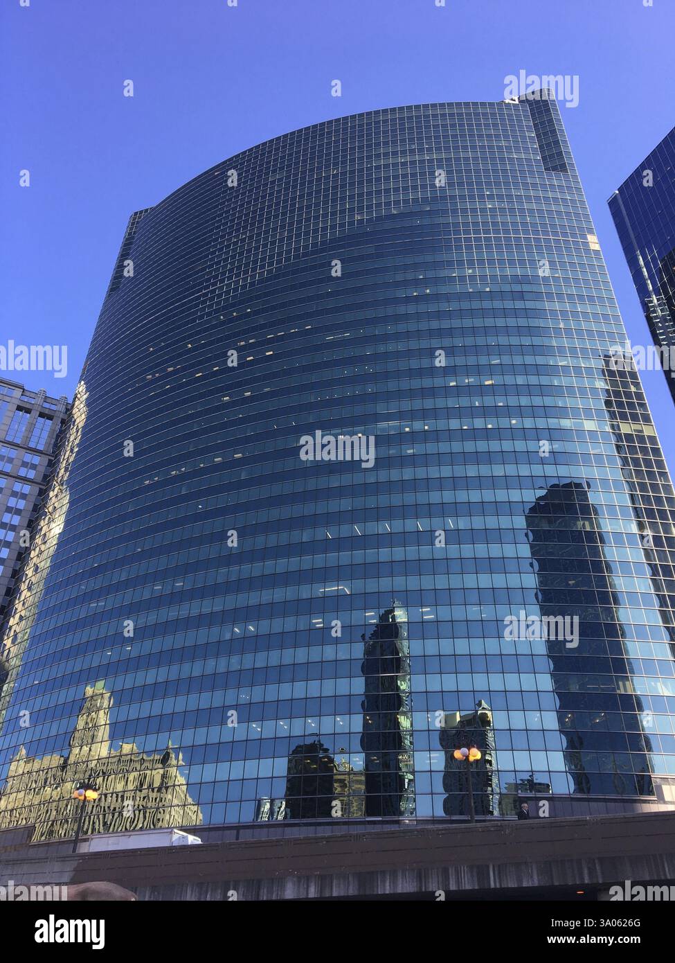 Glass facade of an office building reflects neighbouring architecture ...