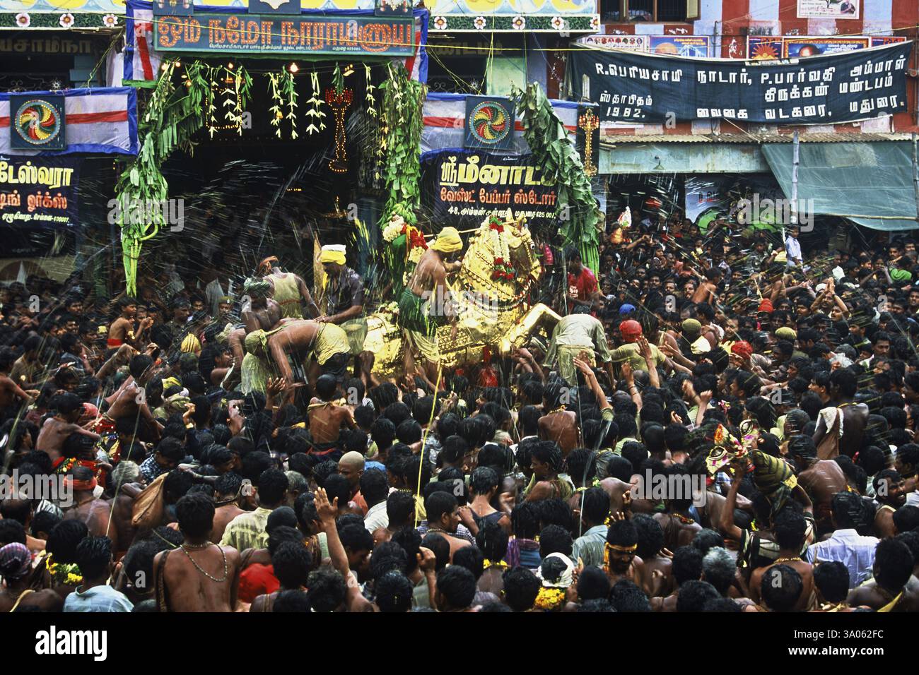 Ritual spraying of water on Kallazhagar Vishnu mounted on golden horse ...